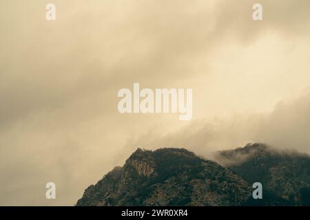mountain peaks covered in mist Stock Photo - Alamy
