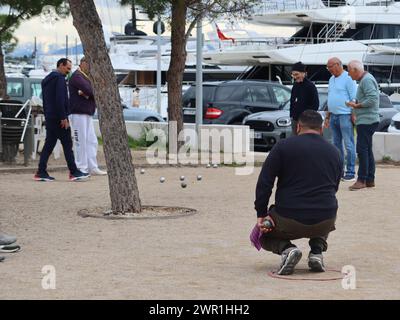 French men playing Petanque, a form of bowling like the Italian bocce ...
