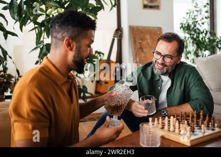 Best friends playing chess together, drinking whiskey and talking ...