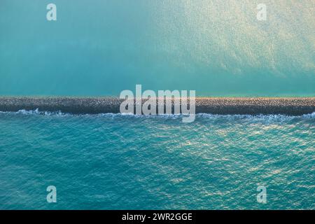 Aerial top view of breakwater construction. Bulldozer and crane on a ...