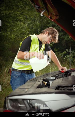 Car driver take care of his car before longer trip and checking oil ...
