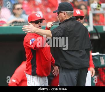 Houston head coach Todd Whitting, center, argues with umpires if a hit ...