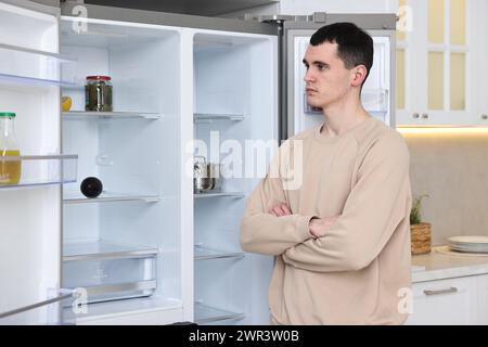 Upset man near empty refrigerator in kitchen, view from inside Stock ...