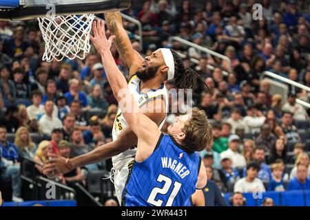 Indiana Pacers forward Isaiah Jackson, center left, is held back by ...