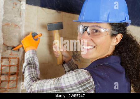 happy woman with hammer and chisel Stock Photo - Alamy