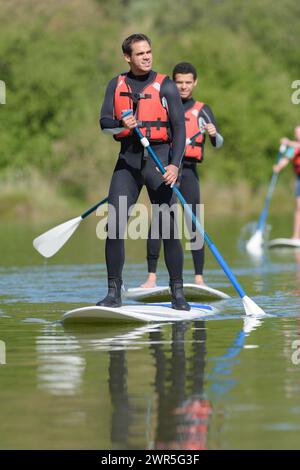 People steer their stand-up paddle boards along Moyka River past ...