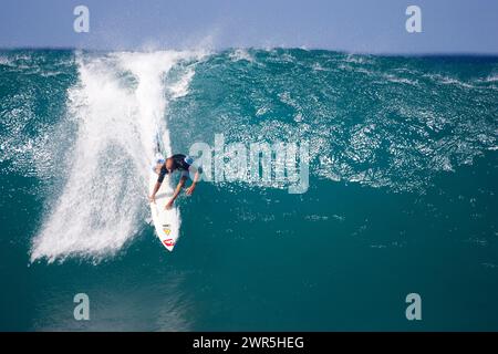 World champion surfer; Kelly Slater surfing at the Pipeline in Hawaii ...