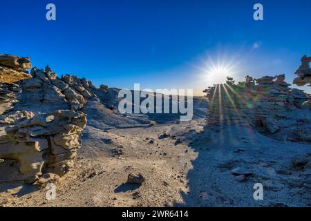 The Smooth sand and towering rock formations in a desert landscape ...