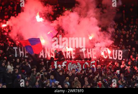 Crystal Palace fans with flares as they hold aloft banners which read ...