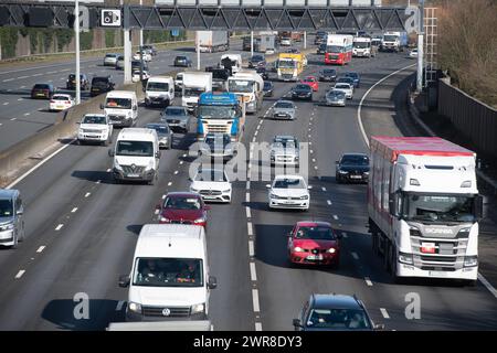 Egham, Surrey, UK. 4th March, 2024. Busy traffic on the M25 Motorway at ...