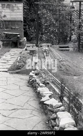 1970s, historical, a model railway built in a back garden, showing the ...