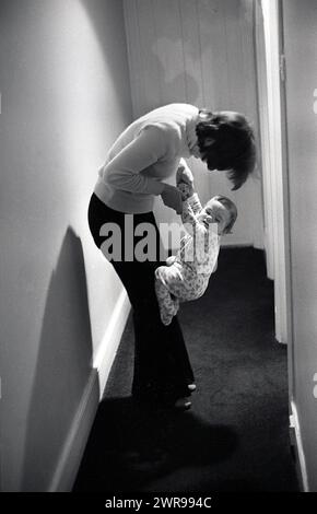 1960s, historical, a mother and infant child sat in small buggy or ...