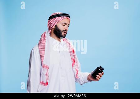 Muslim man is holding pills and bottle Stock Photo - Alamy