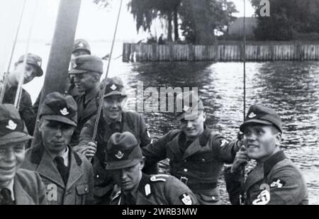 A troop leader and working men of the Reich Labour Service on a sailing ...