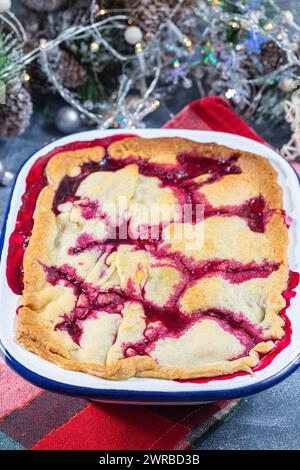 Delicious berry cobbler in enamel baking dish, garnished with ice cream ...