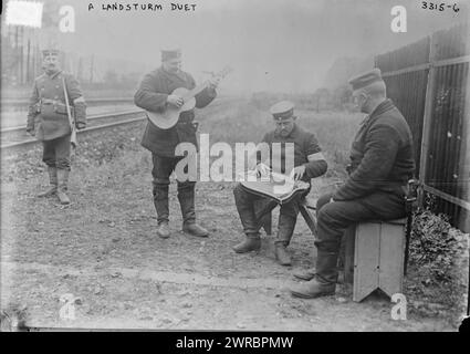 A Landsturm Duet, 1914. Men playing stringed instruments by the ...