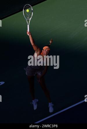 Elise Mertens of Belgium serves against Timea Babos of Hungary and ...