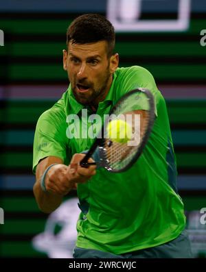 Luca Nardi, of Italy, returns a shot Novak Djokovic, of Serbia, at the ...