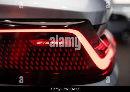 close-up glowing logotype BYD on red taillight, grey BYD Seal U 2024 ...