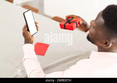 Digital smartphone, blank screen with small petals and white tangled ...