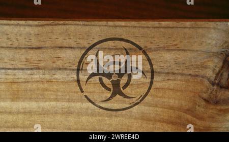 Biohazard warning stamp printed on wooden box. Biological hazard symbol ...