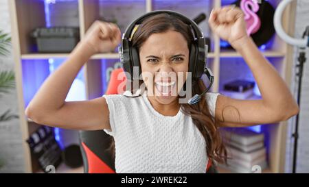 Young beautiful hispanic woman streamer playing video game using ...