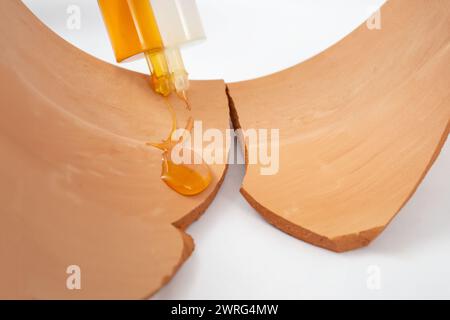 Double syringe with epoxy gel gluing and spilling on genuine brown ...