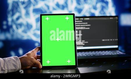 Certified admin using green screen tablet to write artificial intelligence script code in ...