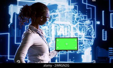 Admin in data center with green screen tablet using artificial intelligence computing simulating ...