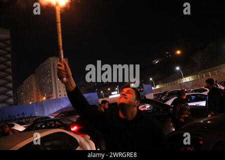 March 12, 2024, Tehran, Iran: An Iranian man jumps over a bonfire on ...