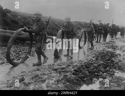 A photograph of British wiring parties during a rainy period, possibly ...
