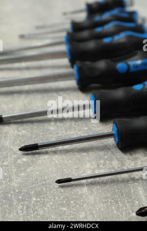Set of screwdrivers on grey table, top view. Space for text Stock Photo ...