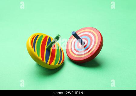 Two bright spinning tops on pink background. Toy whirligig Stock Photo ...
