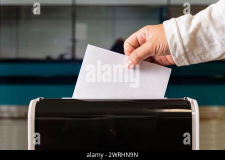 A voter casts her ballot at a polling station during the third phase of ...