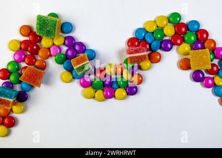 A burst of colorful candies in various shapes and sizes, scattered ...