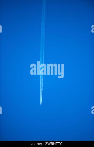 Airplane trails in the blue sky. Two airplanes in the sky, contrails ...