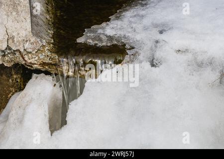 Ice formation at mouth of concrete culvert of flowing water in Daejeon ...