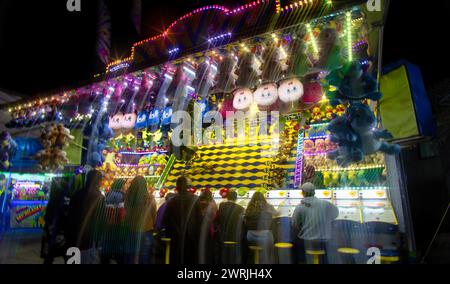 A Mexican fair with rides and lights at night, with space for text ...