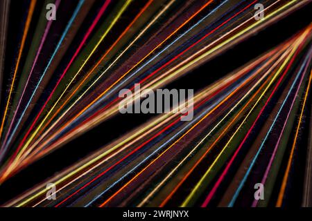 Converging Multi-colored Sewing Thread on a black background Stock ...