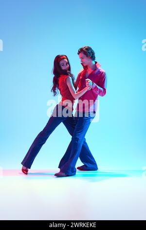 Rock and roll era. Elegant stylish young couple dancing retro dance ...