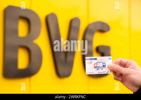 male hand hold electronic Deutschland-Ticket, BVG logo Berliner ...