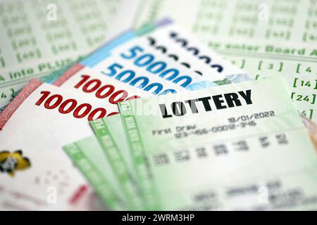 Green lottery tickets and indonesian money bills on blank with numbers ...