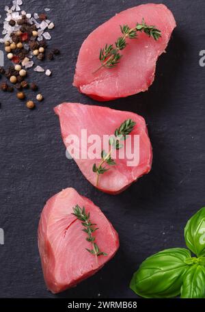 Raw tuna fillets and spices on white table, closeup Stock Photo - Alamy
