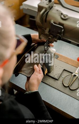 A meticulous cropped unrecognizable shoemaker in Austria works on a ...