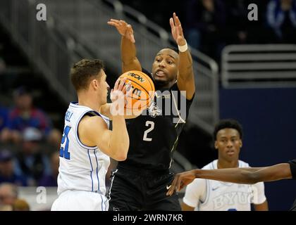 BYU guard Trevin Knell (21) dribbles the basketball guarded by Utah ...