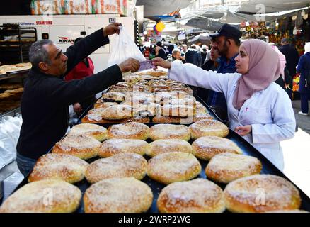 Damascus, Syria. 13th Mar, 2024. People shop for Maarouk sweets ...