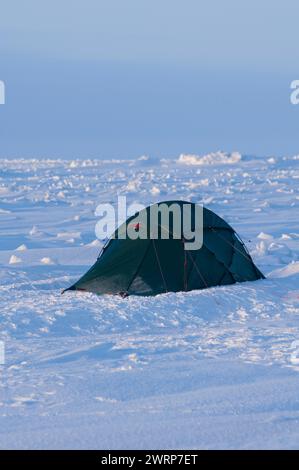 Photographer Steven Kazlowski with camera, tripod at the edge of an ...