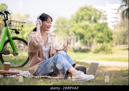 Just chilling. a young woman listening to music while relaxing at home ...