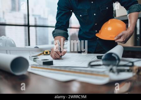 Engineering working with drawings inspection on the office desk and ...