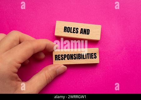 Roles and responsibilities words written on torn yellow paper with ...